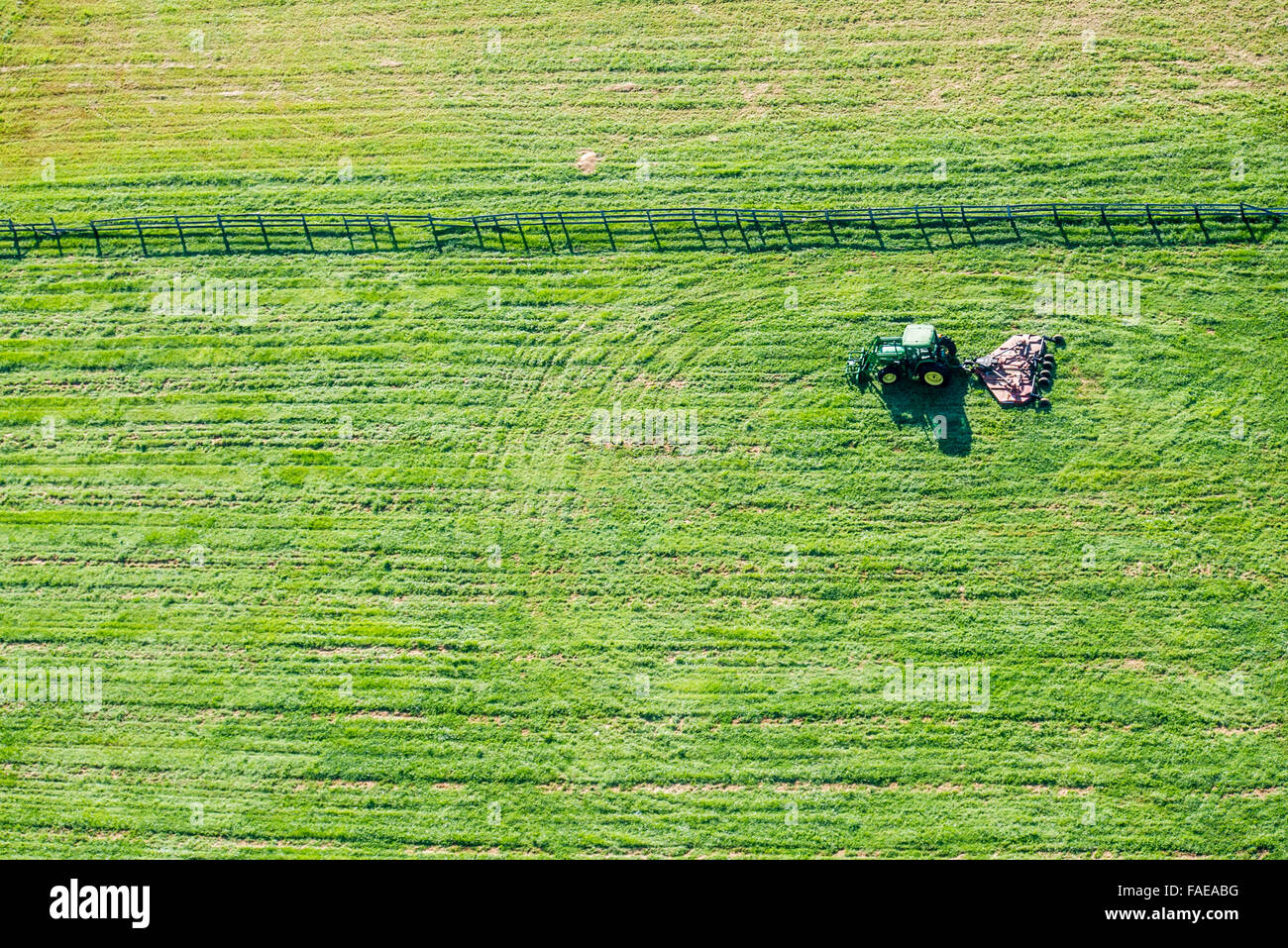 Aerial view of a tractor working through a field Stock Photo - Alamy