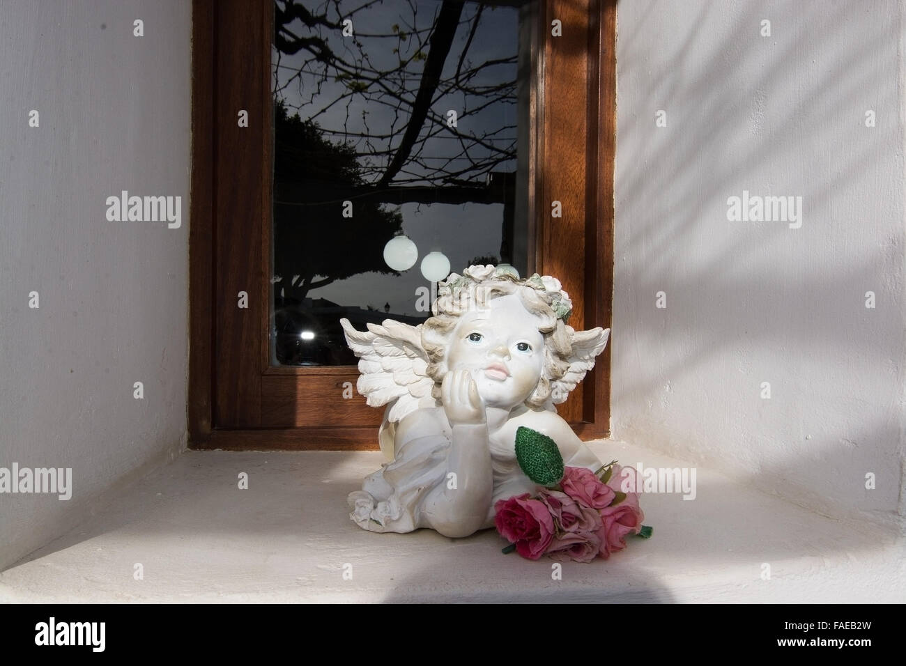 Angel with rose in window at Angels Ibiza outdoor display in Santa ...