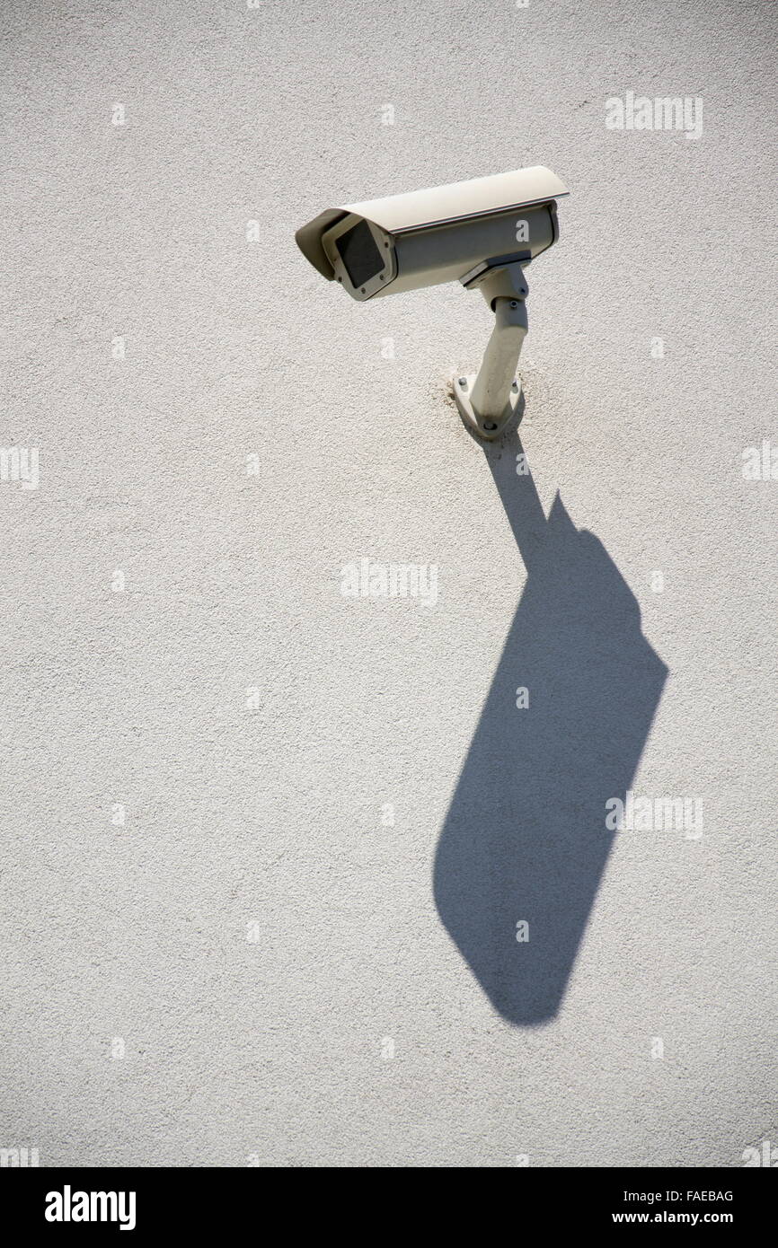White security cameras mounted on white wall Stock Photo - Alamy