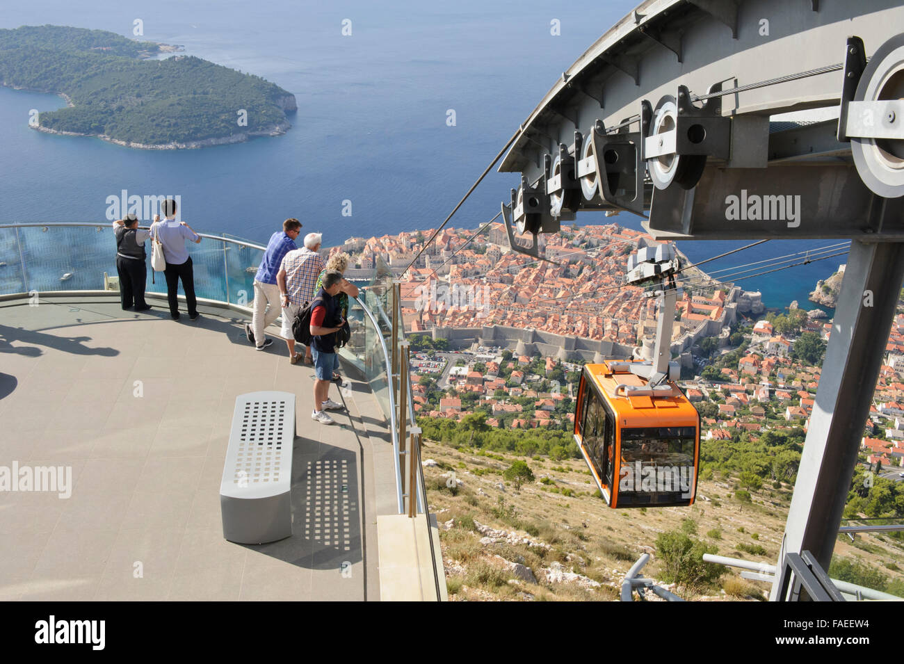 Tourists on a lookout platform on the hilltop with the Lokrum island ...