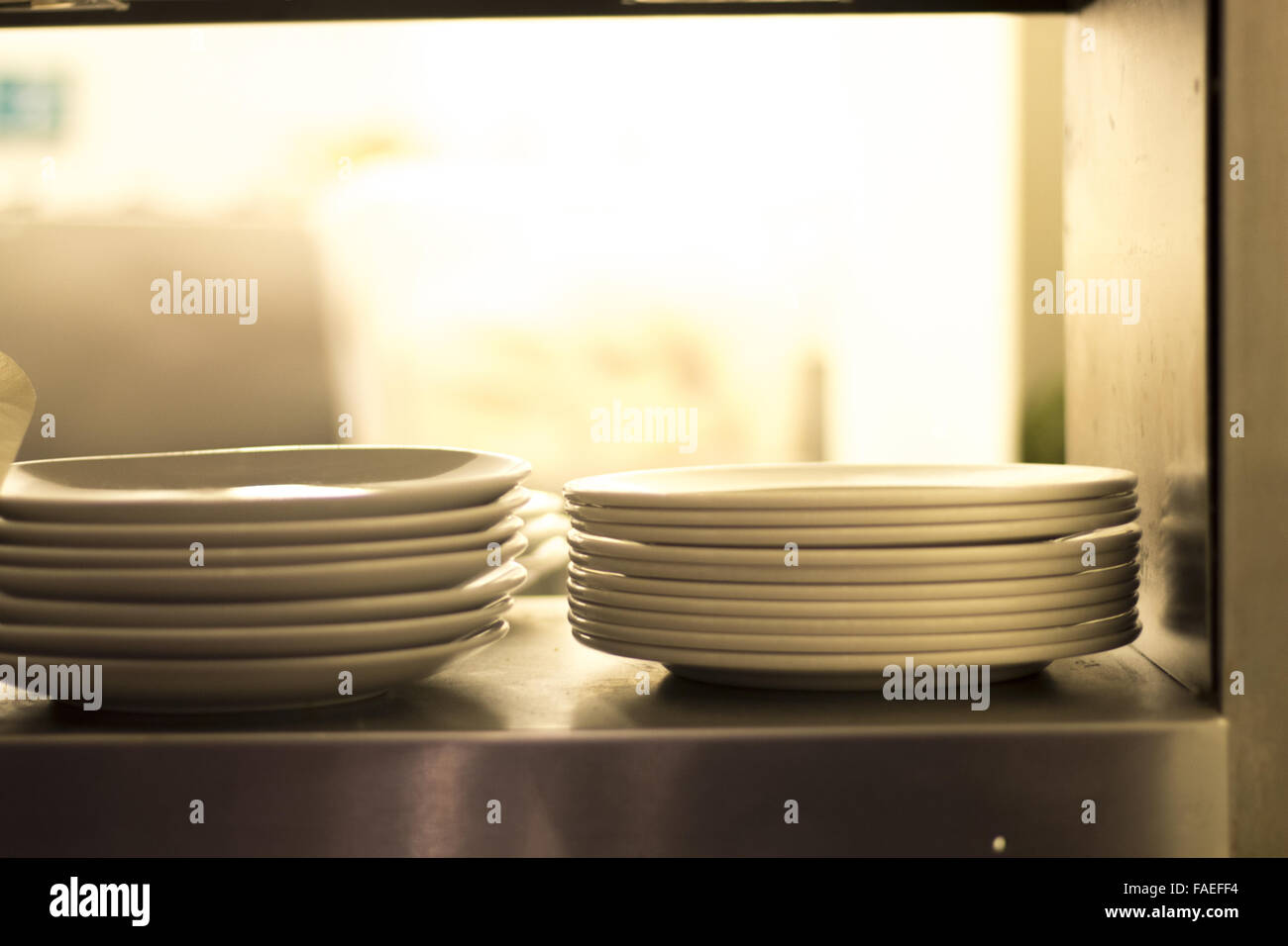 Plates in restaurant cafe kitchen photo Stock Photo - Alamy