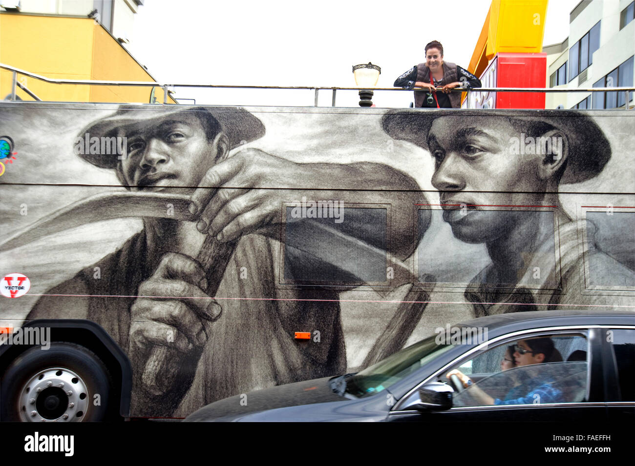 A Charles Wilbert White painting is reproduced on the side of a city ...