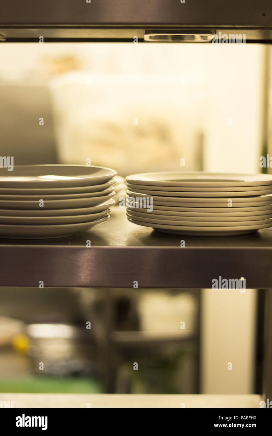 Plates in restaurant cafe kitchen photo Stock Photo - Alamy