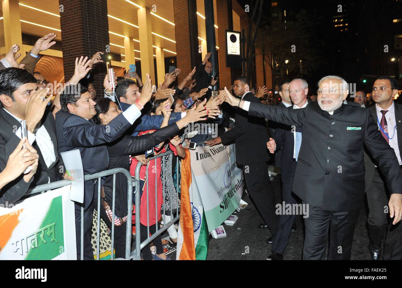 Indian Prime Minister Narendra Modi reaches out to greet supporters as ...