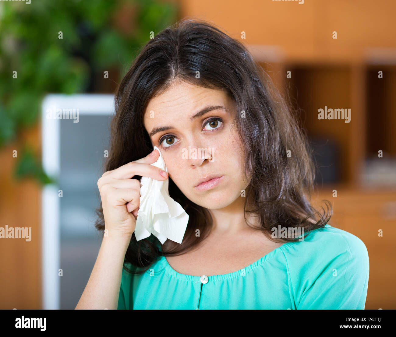 Young brunette woman crying at home closeup Stock Photo - Alamy