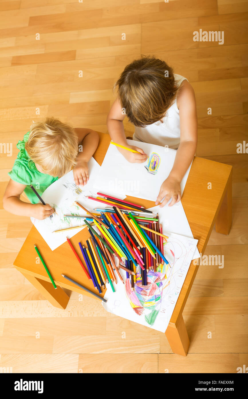 Two year children together with pencils in home interior Stock Photo ...