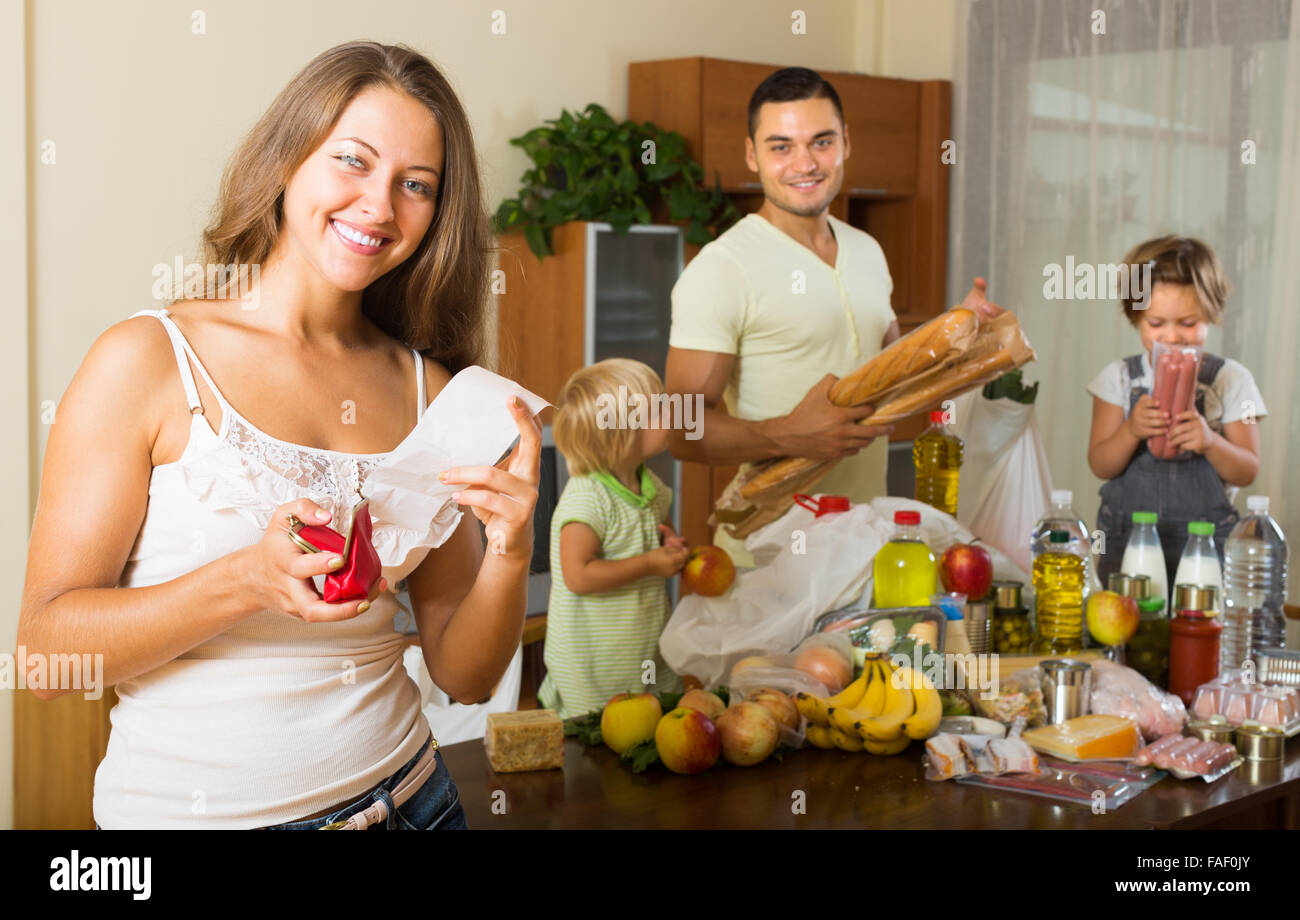 Middle-class family of four with bags of food at home Stock Photo - Alamy