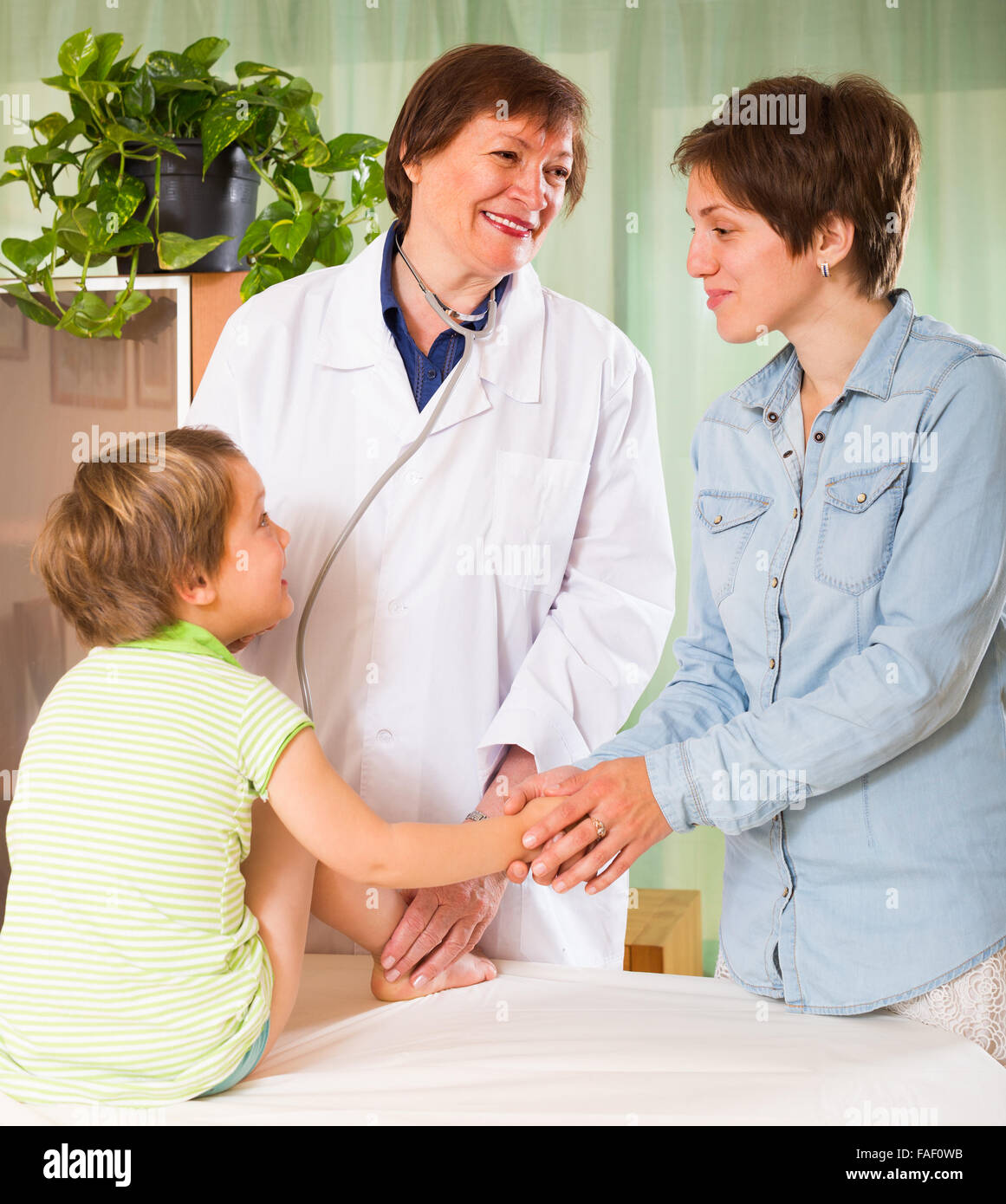 Pediatrician doctor examining child at clinic office Stock Photo - Alamy