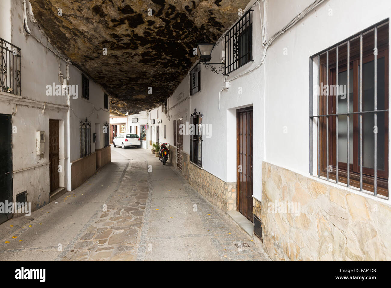 Street with dwellings built into rock overhangs above the Rio Trejo ...