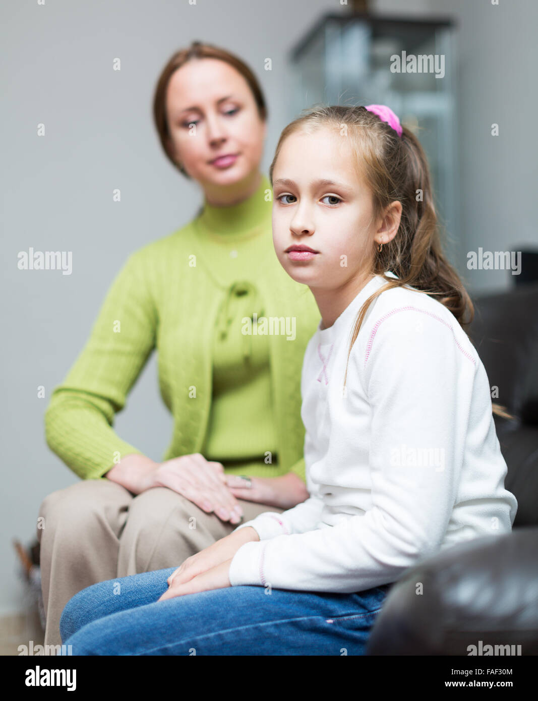 Woman berating little daughter in home interior Stock Photo - Alamy