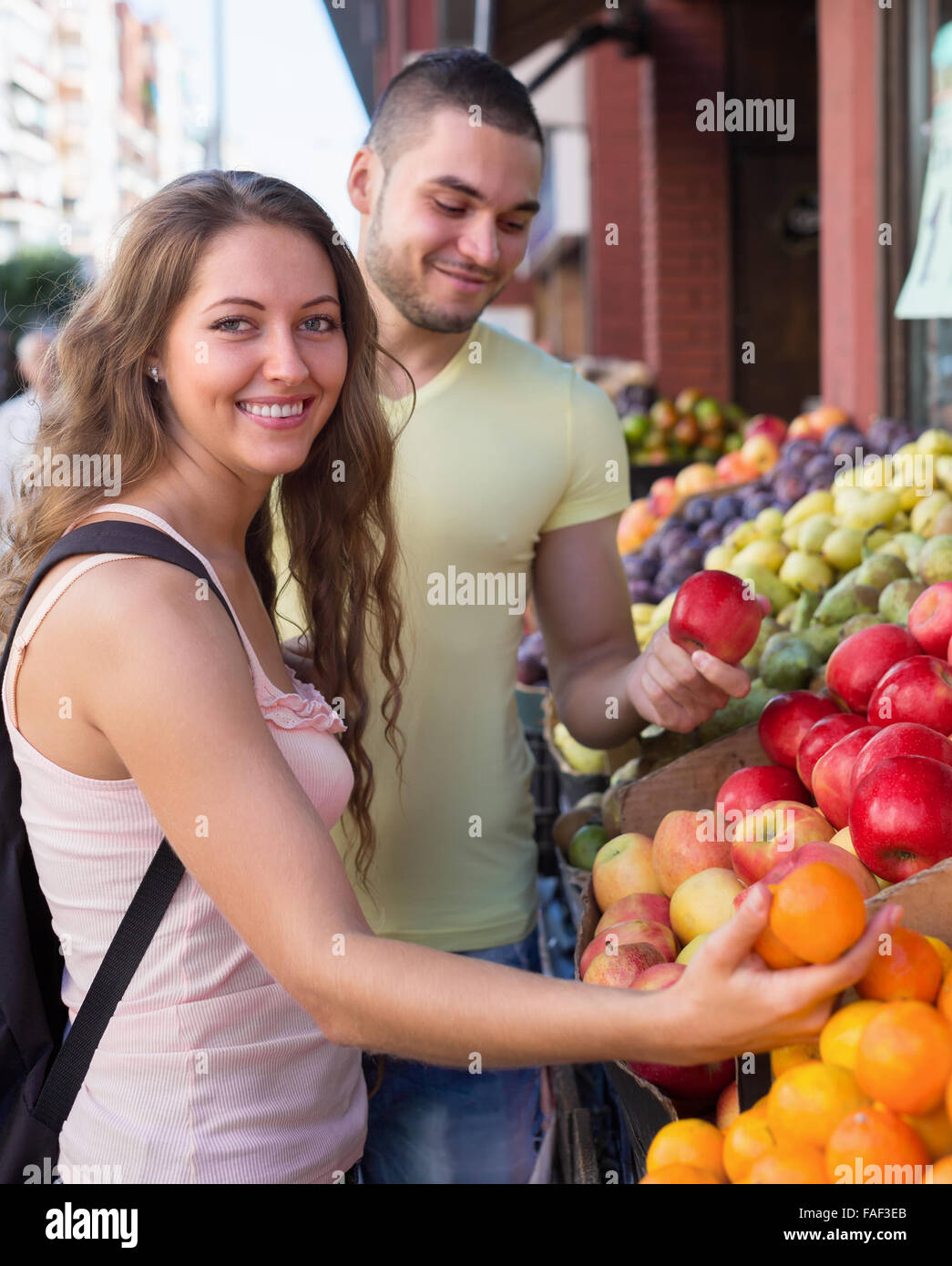 Young couple choosing fruits from stand outdoor Stock Photo - Alamy