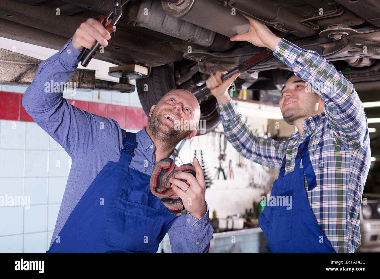 Two mechanics in uniform repairing hi-res stock photography and images ...