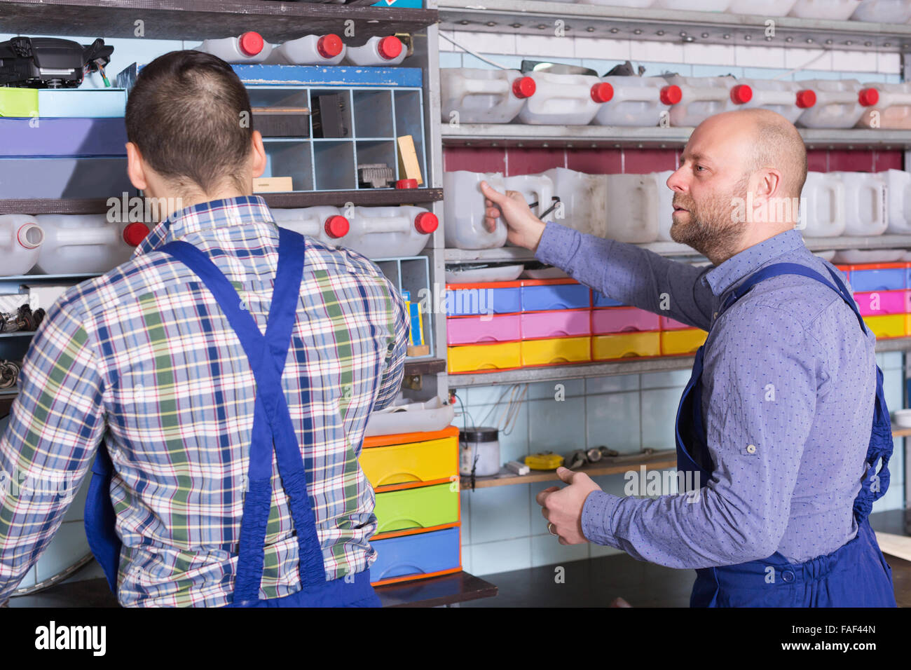 Inside garage two mechanics hi-res stock photography and images - Alamy