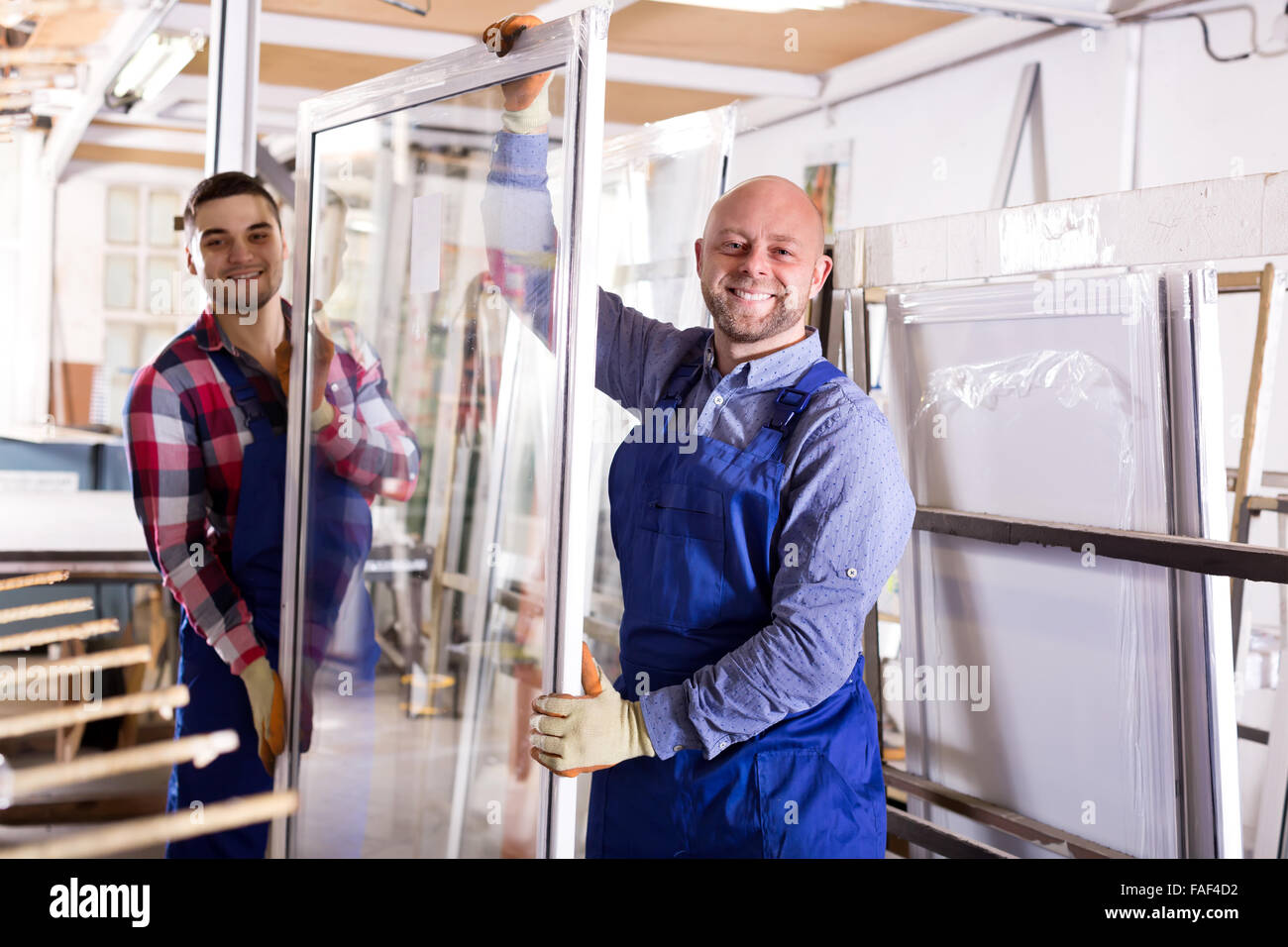 Two production workers inspecting windows at workshop Stock Photo - Alamy
