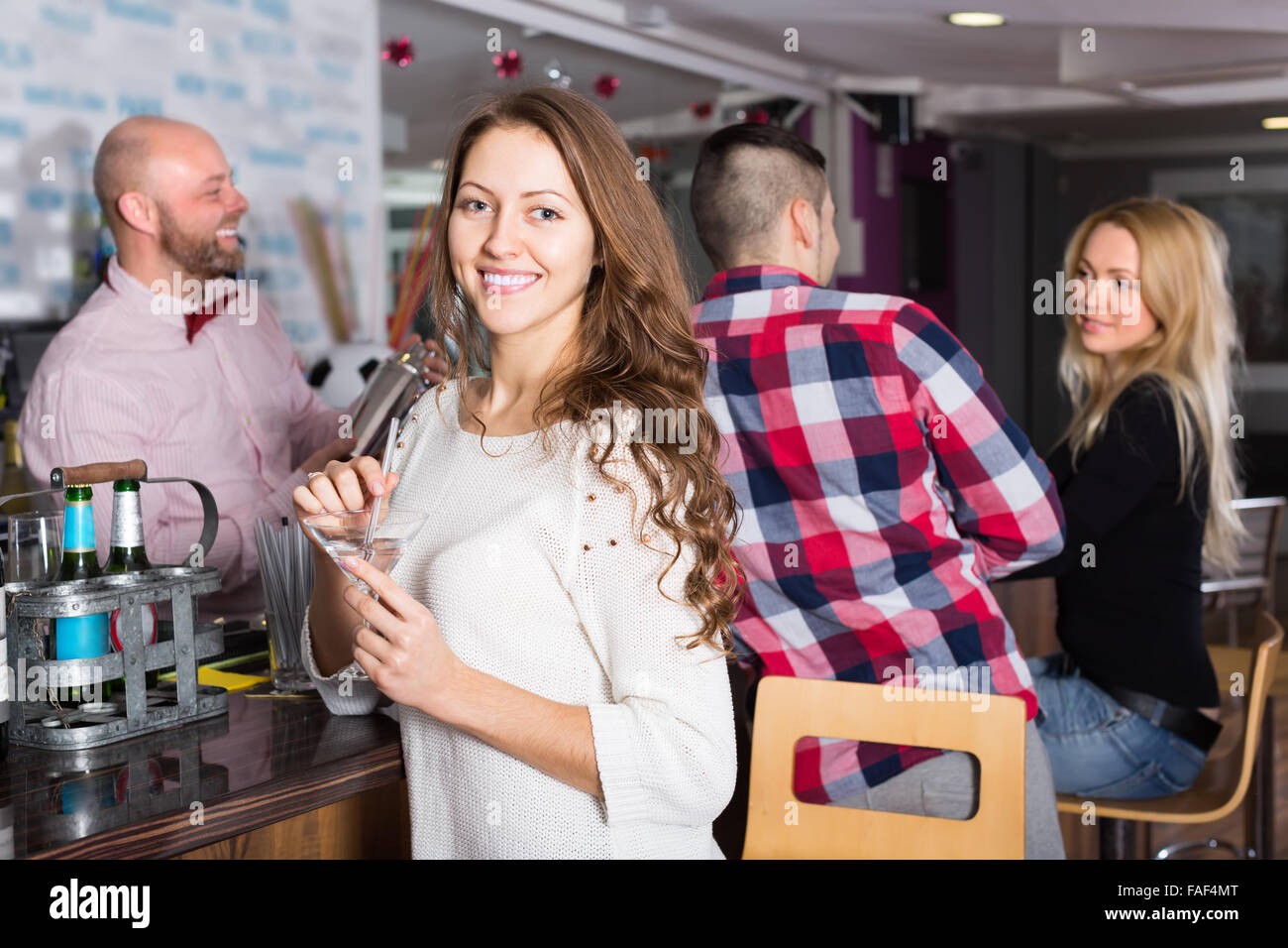 Group of cheerful smiling young friends hanging out in bar Stock Photo ...