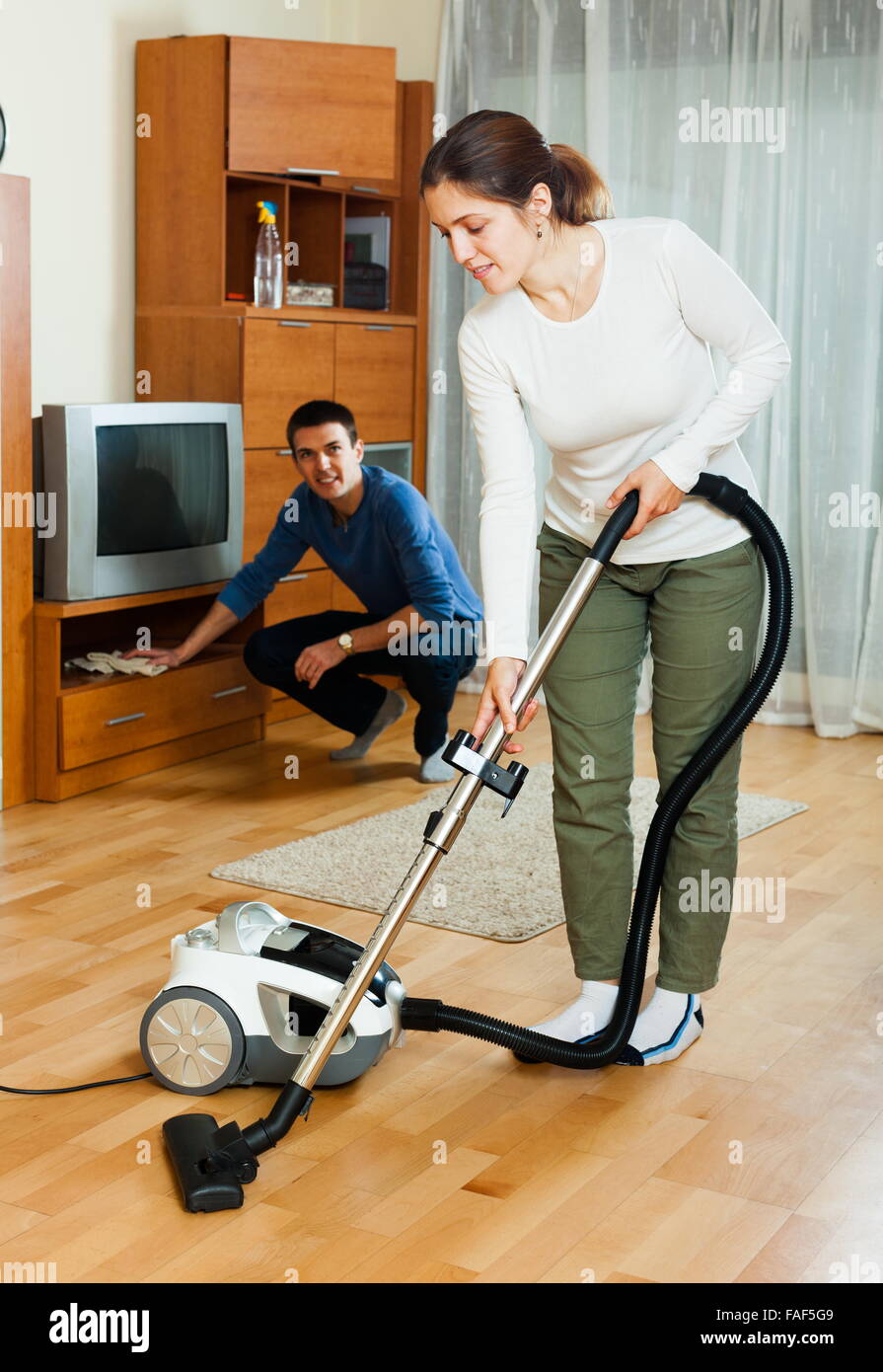 Ordinary couple doing housework together in home Stock Photo - Alamy