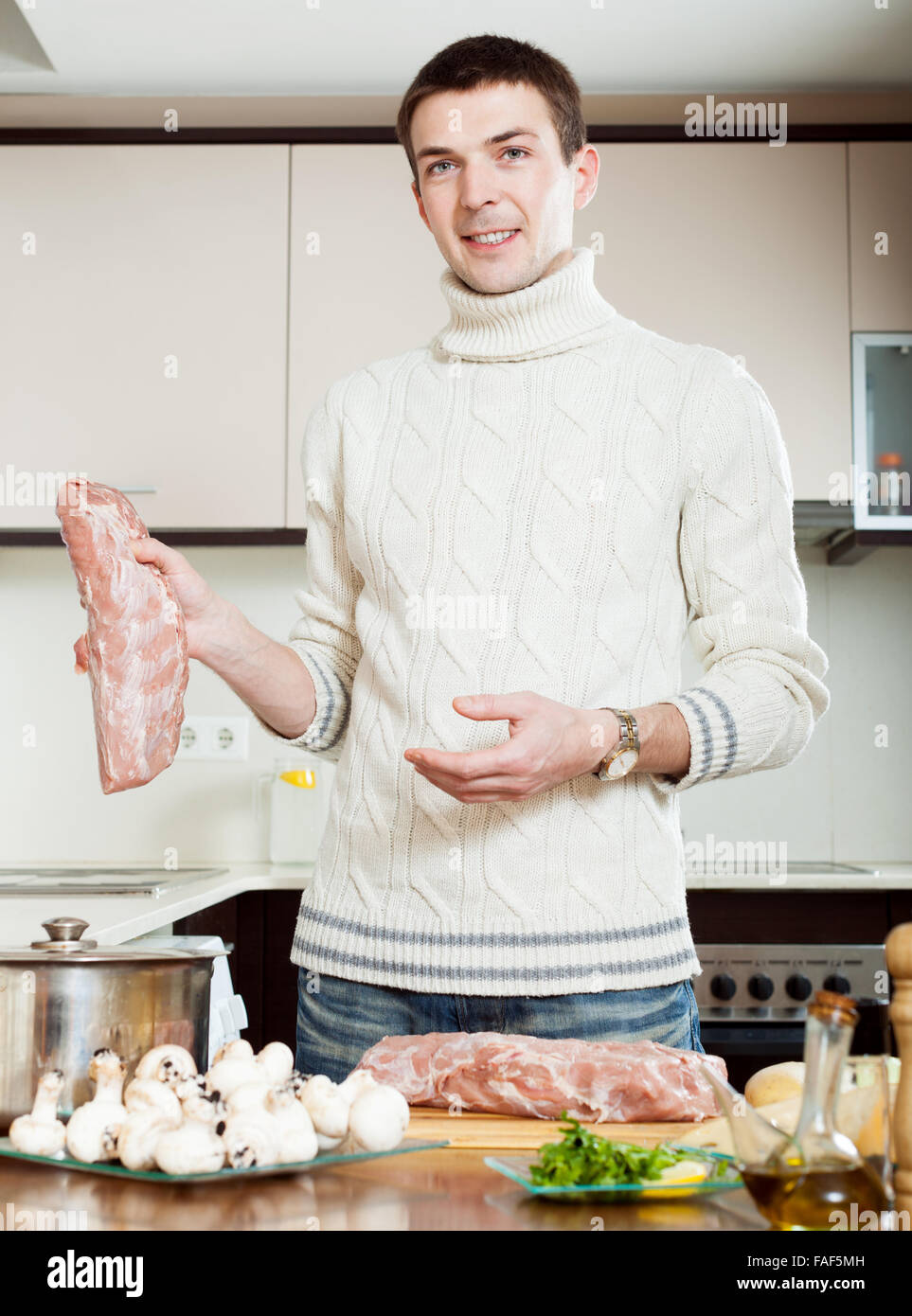 Ordinary man cooking meat hi-res stock photography and images - Alamy