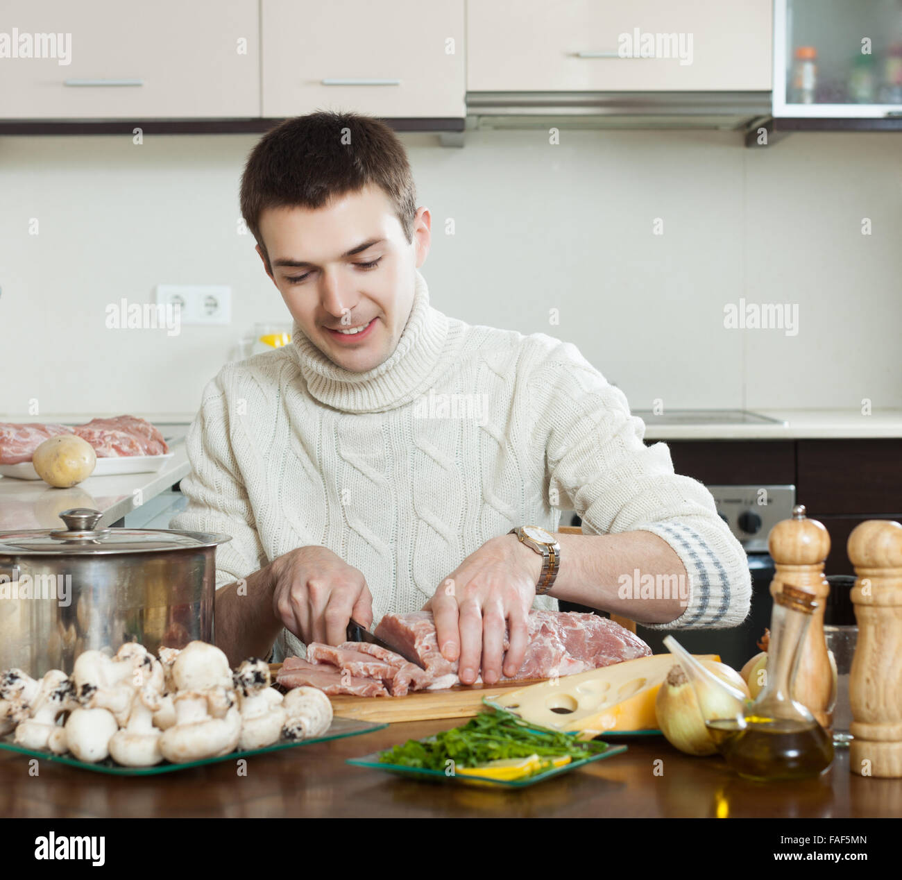 man cooking french-style meat at kitchen. Hands cutting meat Stock ...