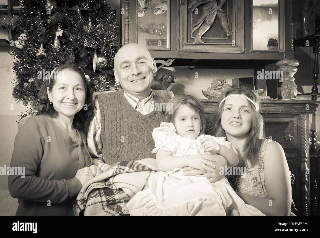 aged photo of happy family of three generations at Christmas time or ...