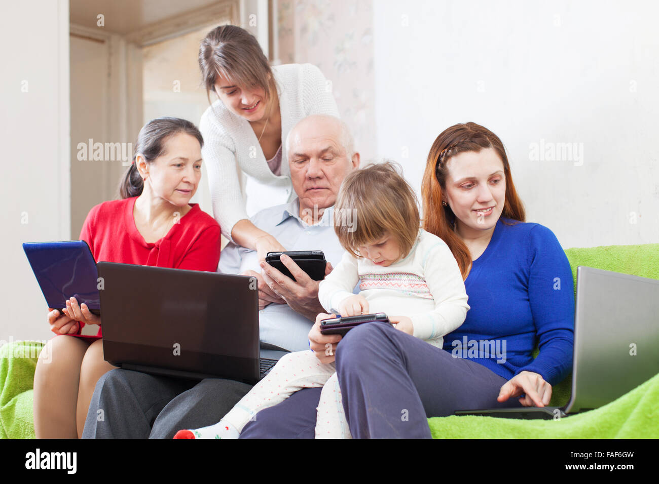 family uses few various portable computers in home Stock Photo - Alamy