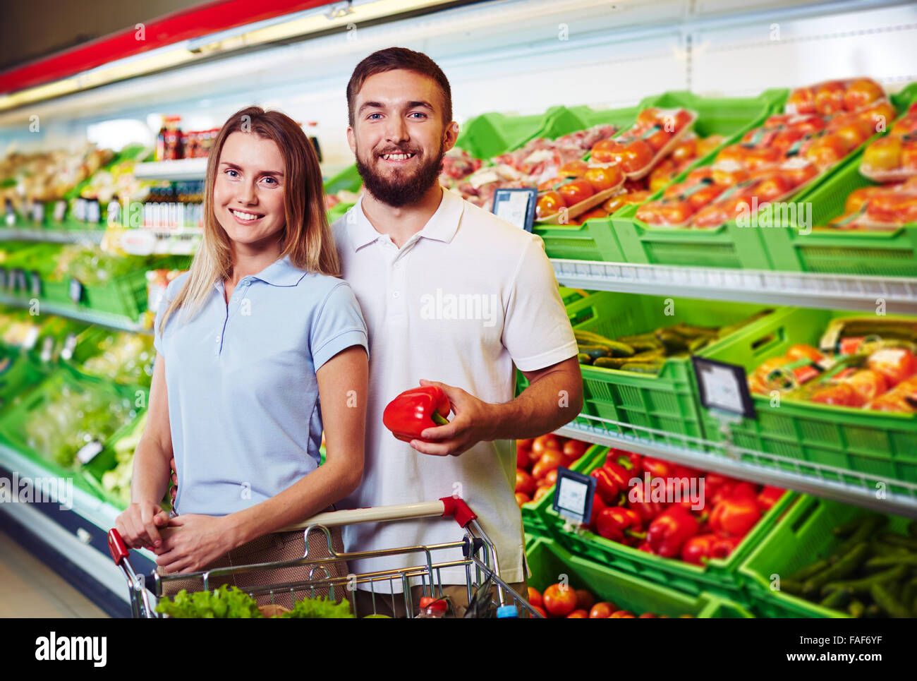 Young family couple choosing vegetables in supermarket Stock Photo - Alamy