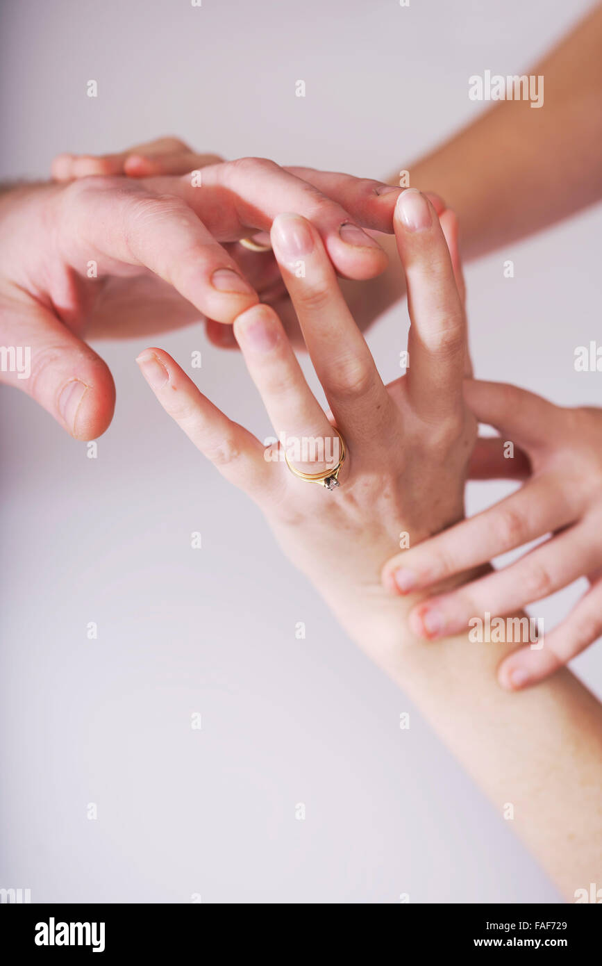 Child holds the hands of mother and father during a fragmented and ...
