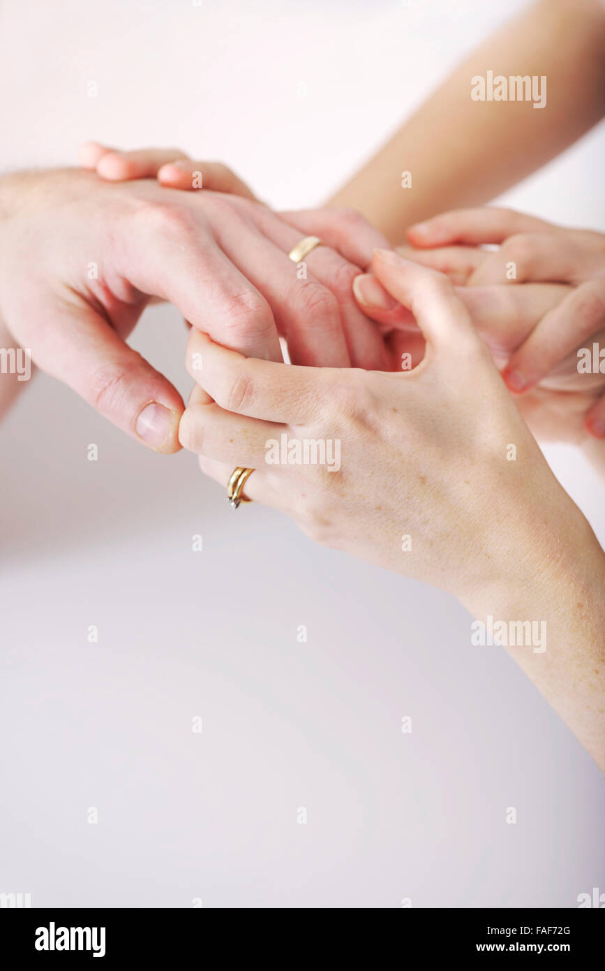 Child holds the hands of mother and father during a fragmented and ...
