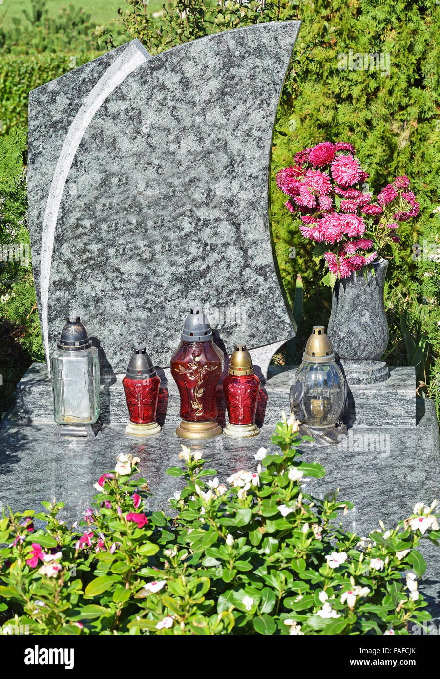 Tombstone and lantern in the public cemetery Stock Photo - Alamy