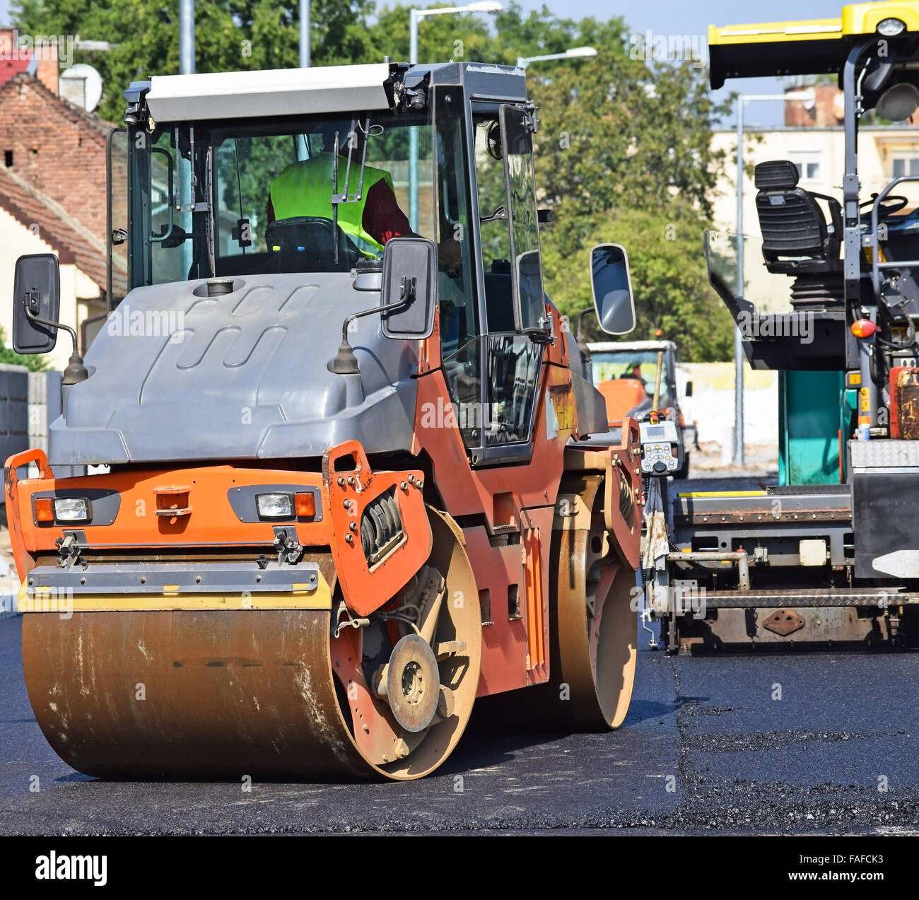 Steamroller at the road construction in the city Stock Photo - Alamy