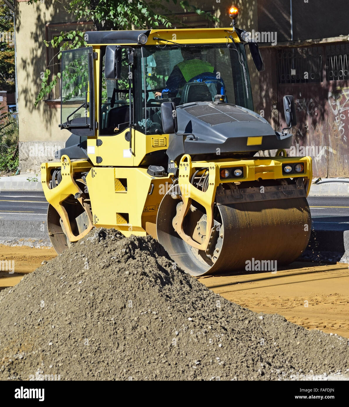 Steam roller at the road construction in the city Stock Photo - Alamy