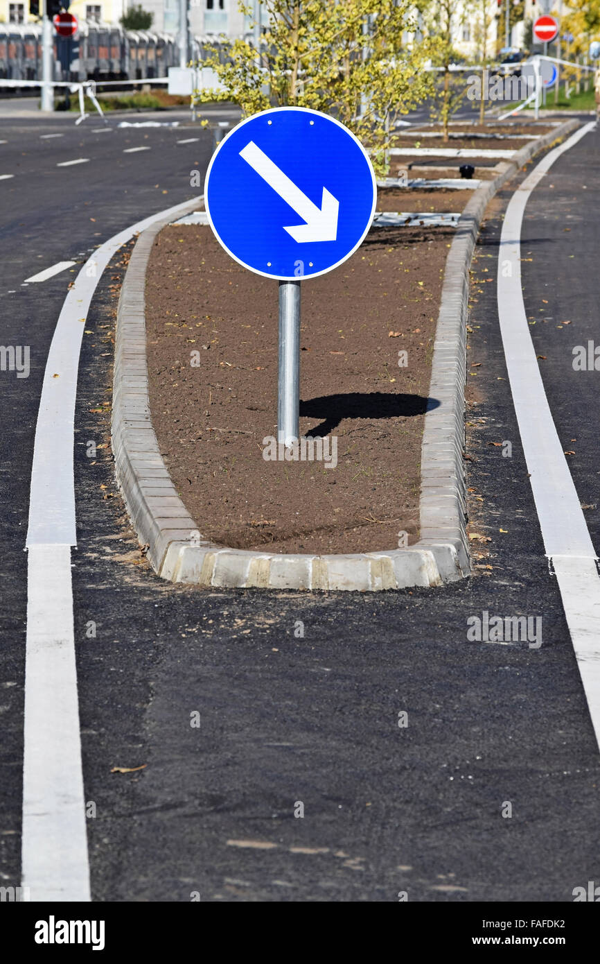 Arrow sign at the road crossing in the city Stock Photo - Alamy