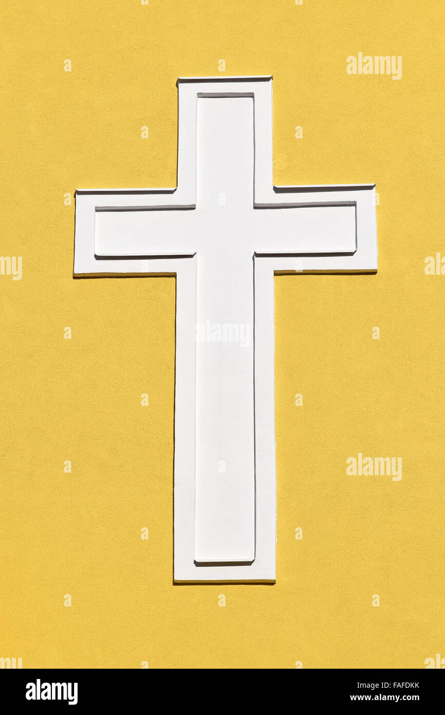 White cross on the yellow wall of the church Stock Photo - Alamy
