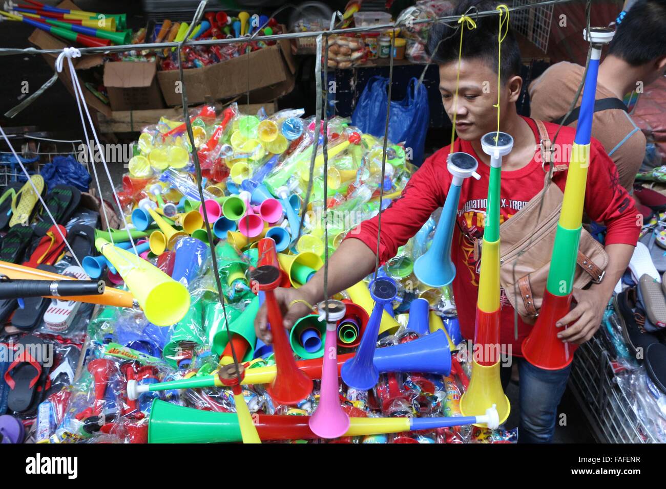 Manila, Philippines. 29th Dec, 2015. A trumpet vendor arrange his ...