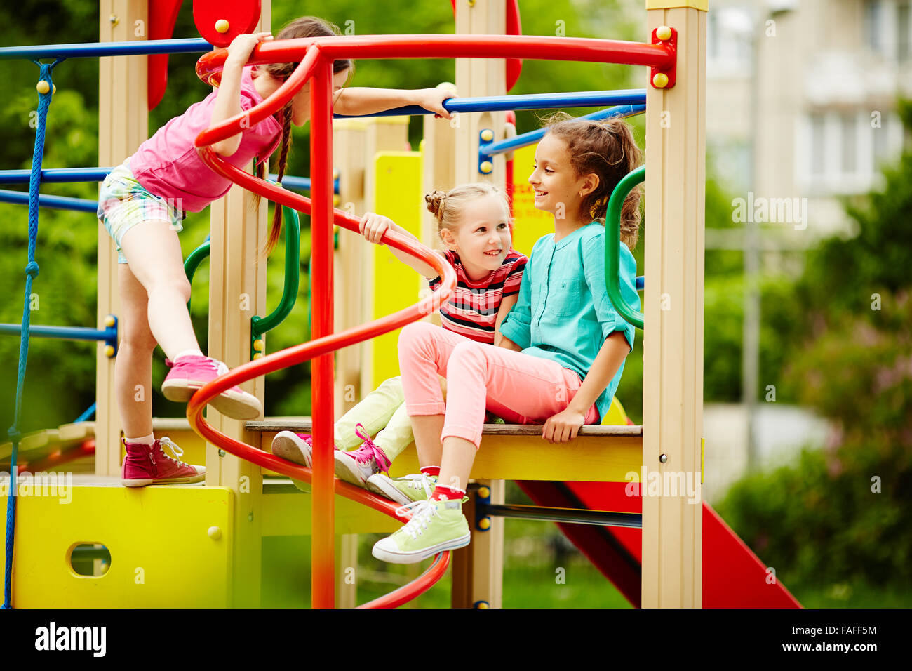 Three girls playing together on playground Stock Photo - Alamy