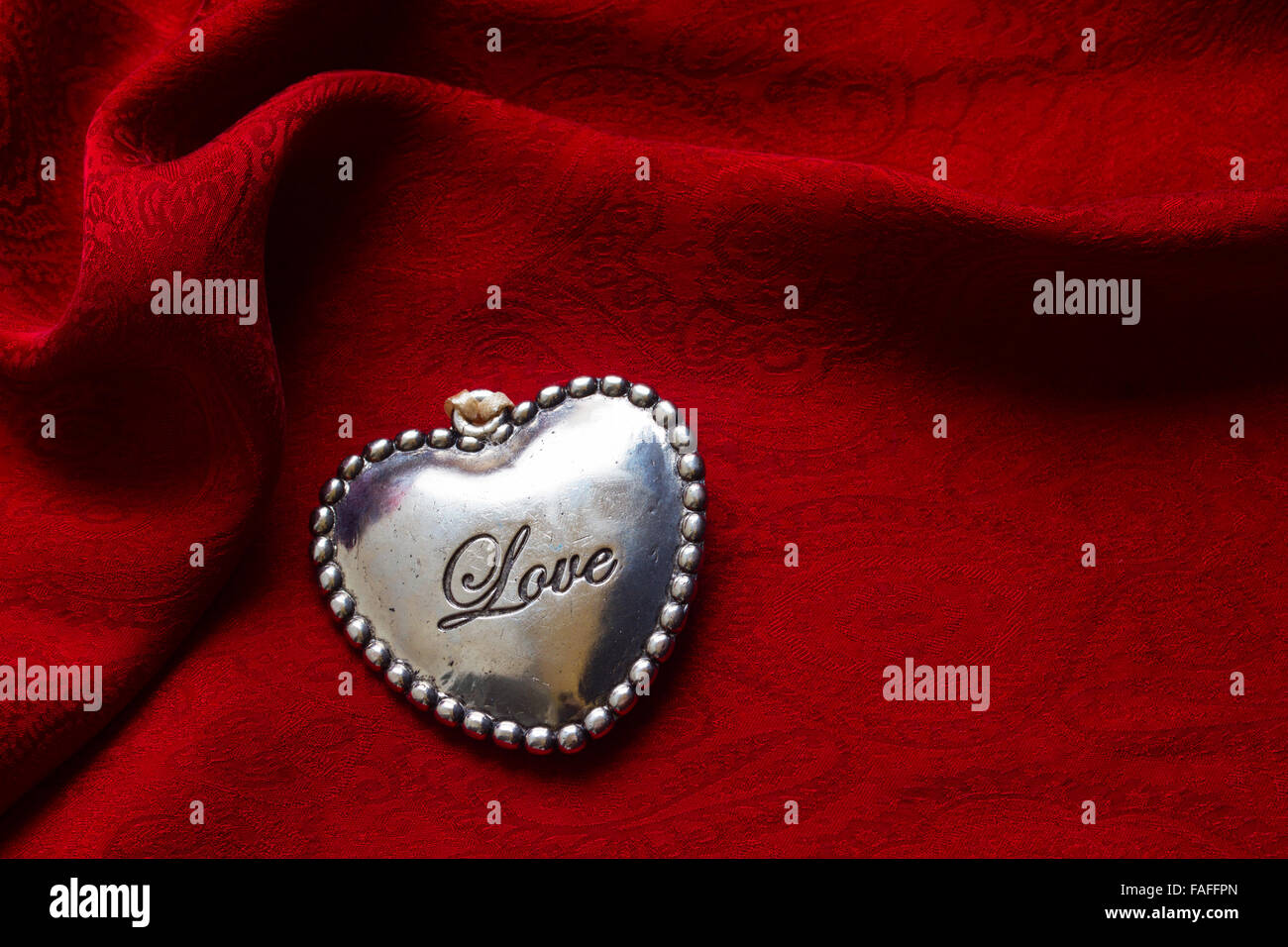 heart on red silk background Stock Photo - Alamy