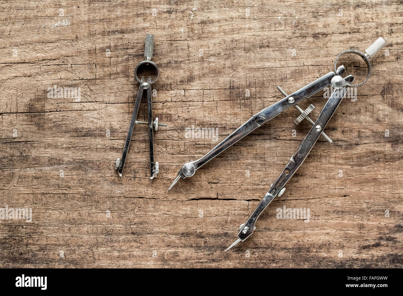 two compasses on the old wooden vintage table Stock Photo - Alamy