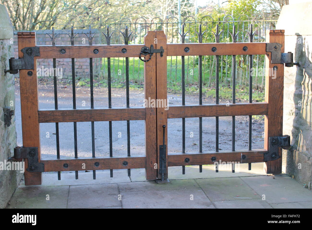 Wooden studded gate with spikes and latch Stock Photo - Alamy
