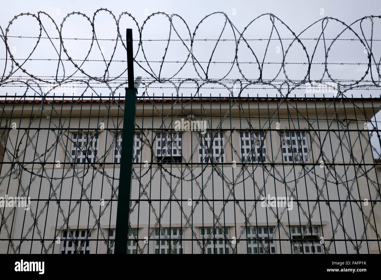 Prison walls with barbwire Stock Photo - Alamy