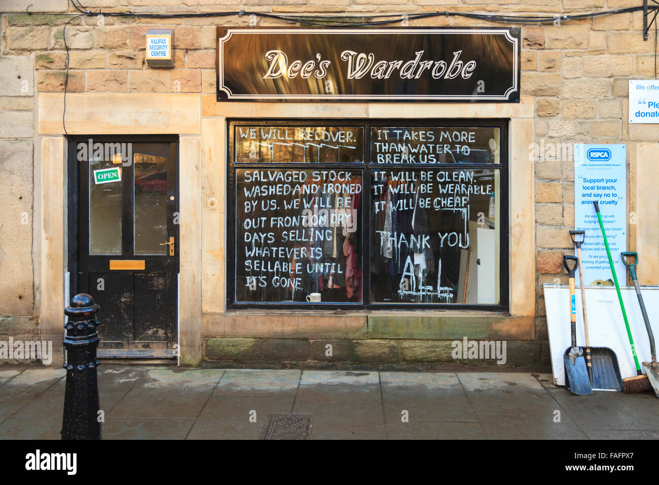 Hebden Bridge, UK. 29th Dec, 2015. Defiant sign in the window of one of ...
