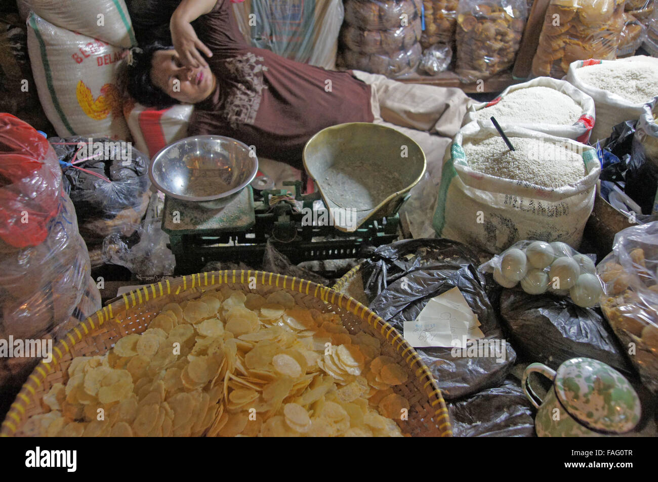 Sleeping spice seller at market Stock Photo - Alamy