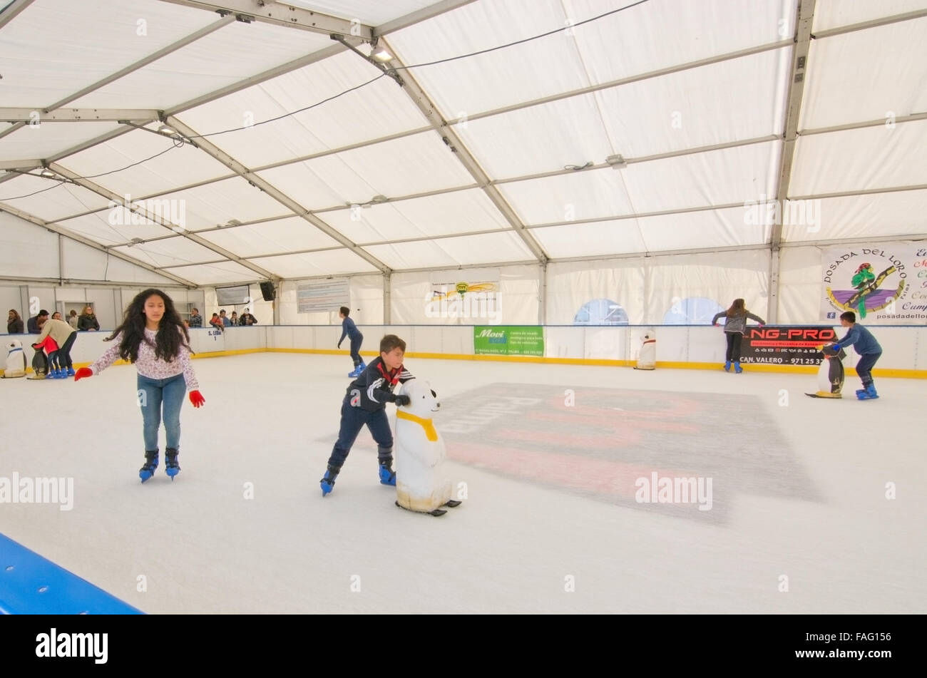 People skate on the temporary winter ice skating rink on Plaza Espana ...