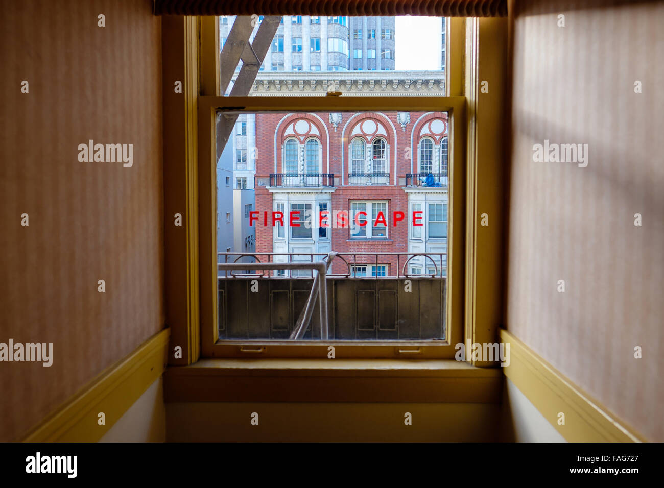 Fire escape through a window in an old building in an urban downtown ...