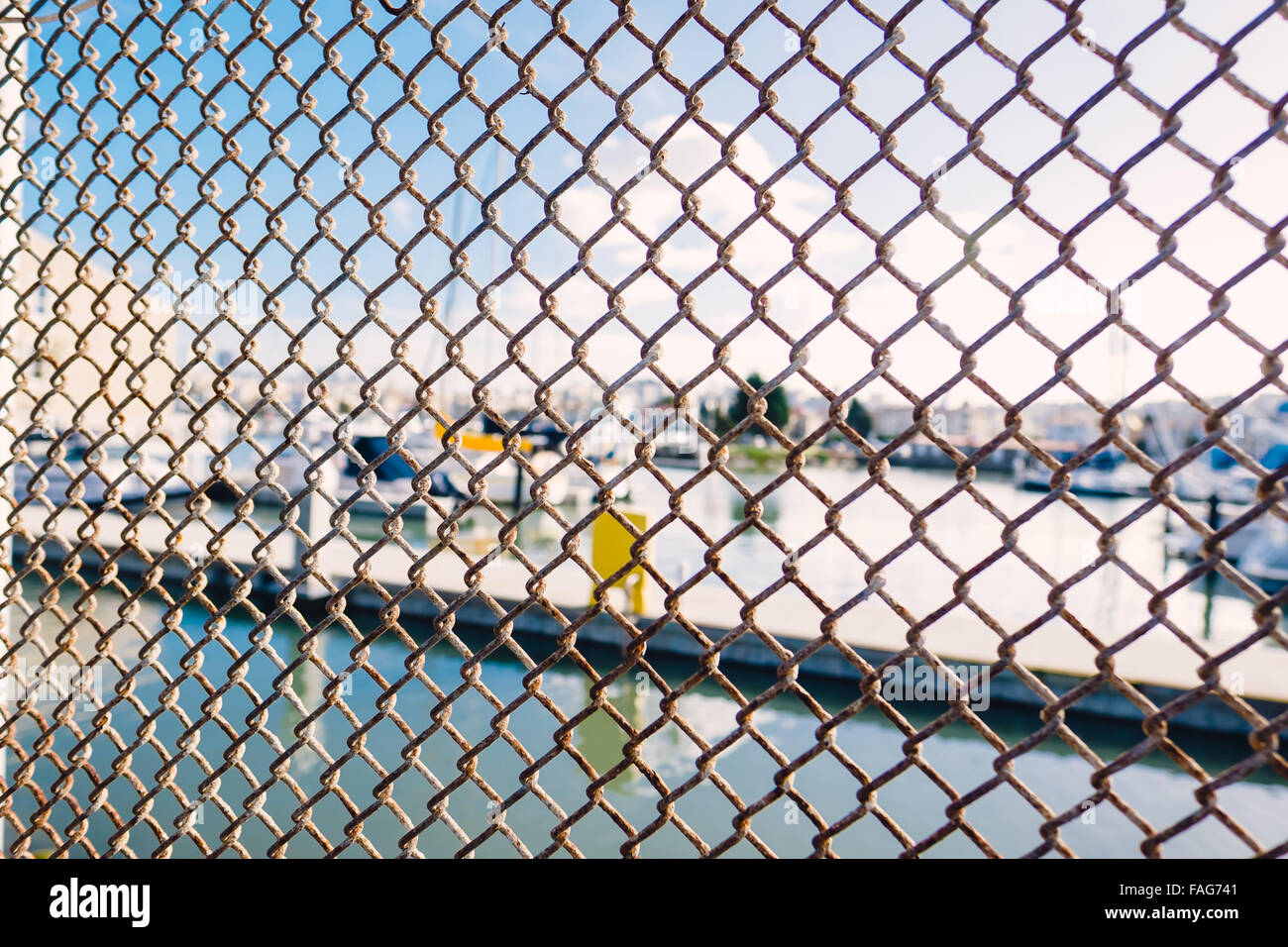 Marina fence is weathered and rusted from salt water spray and weather ...
