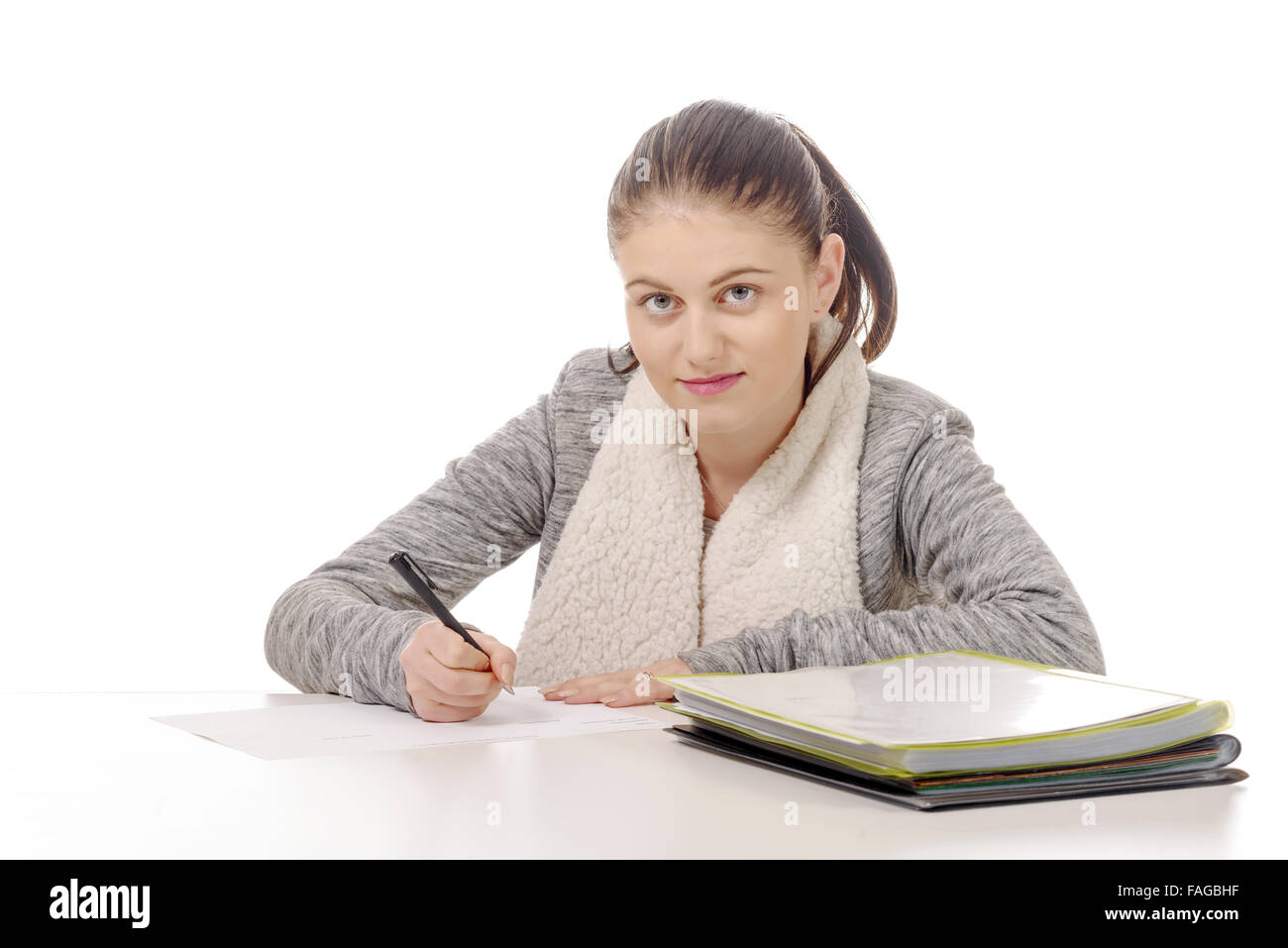 a pretty young woman writing on her desk Stock Photo - Alamy