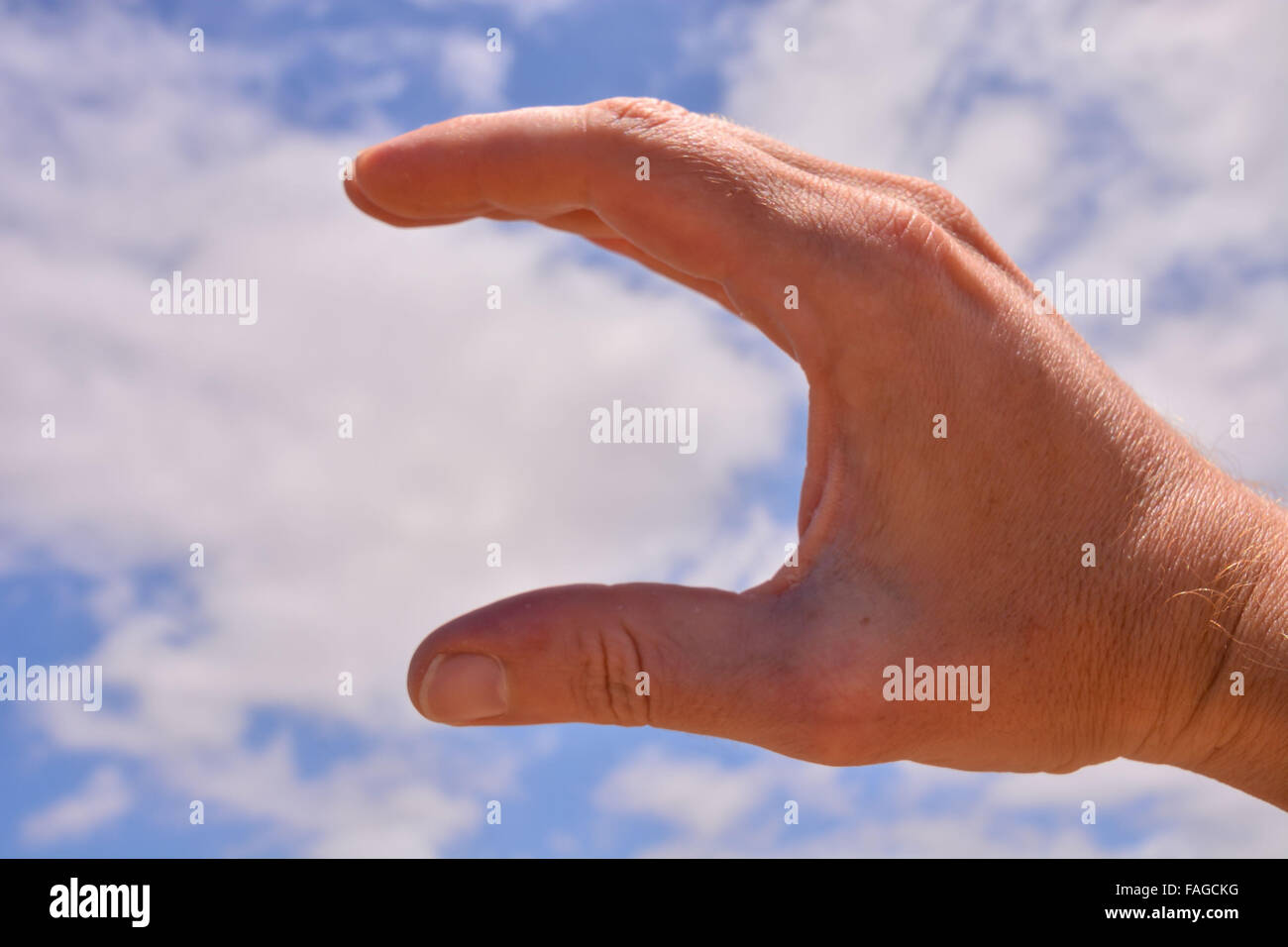 Hand over a Cloudy Sky Stock Photo - Alamy