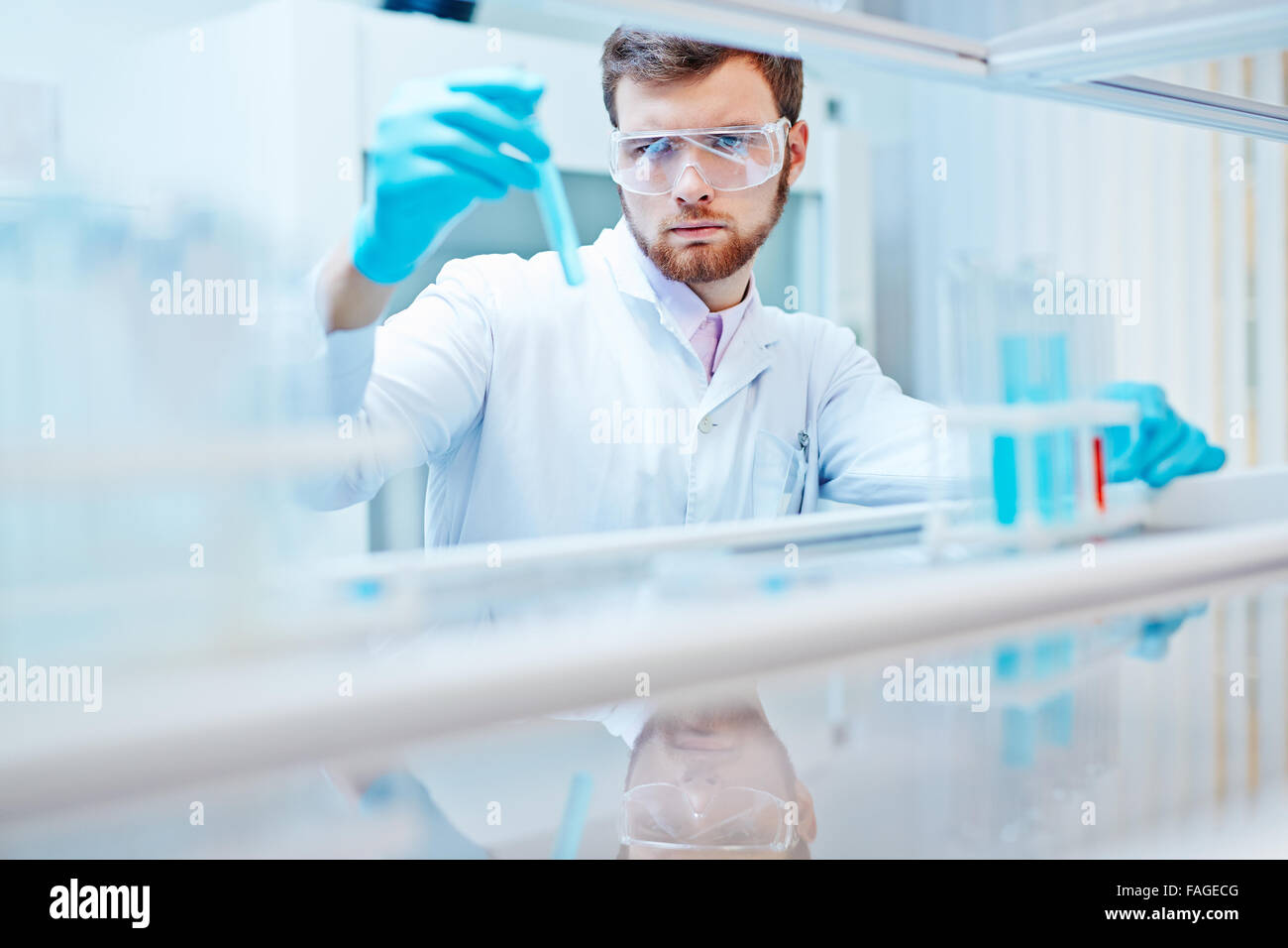 Serious chemist looking flask substance hi-res stock photography and ...