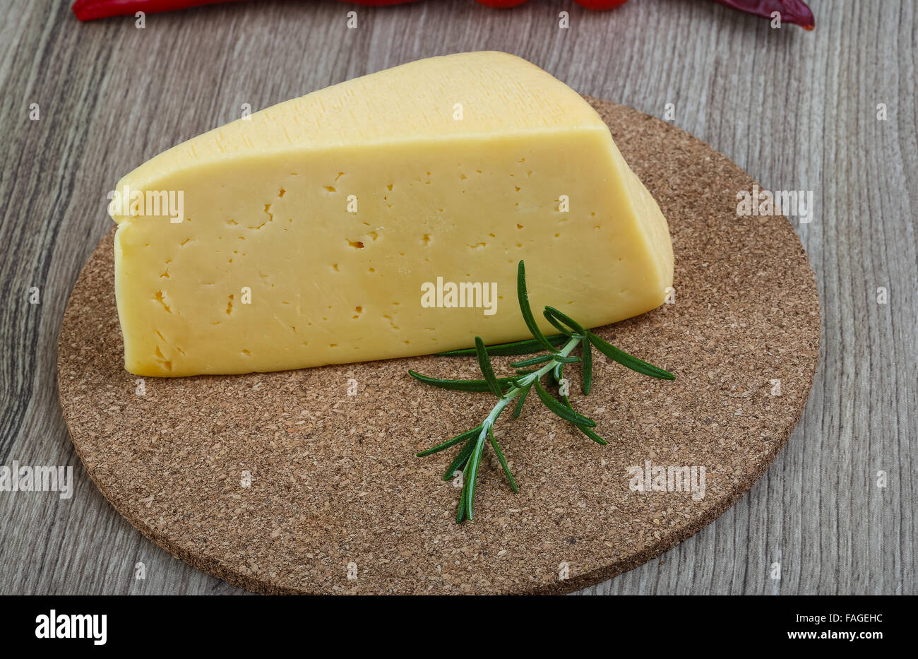 Yellow cheese triangle with rosemary herbs on the wood background Stock ...