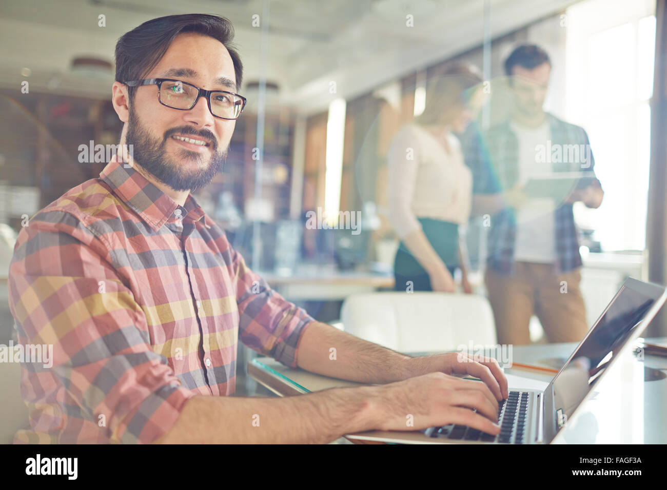 Asian businessman typing in office Stock Photo - Alamy