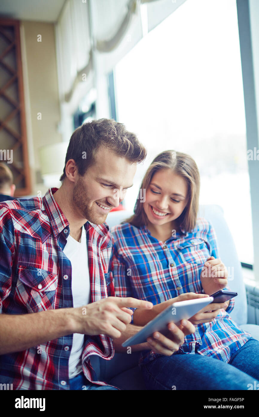 Young couple networking in cafe Stock Photo - Alamy