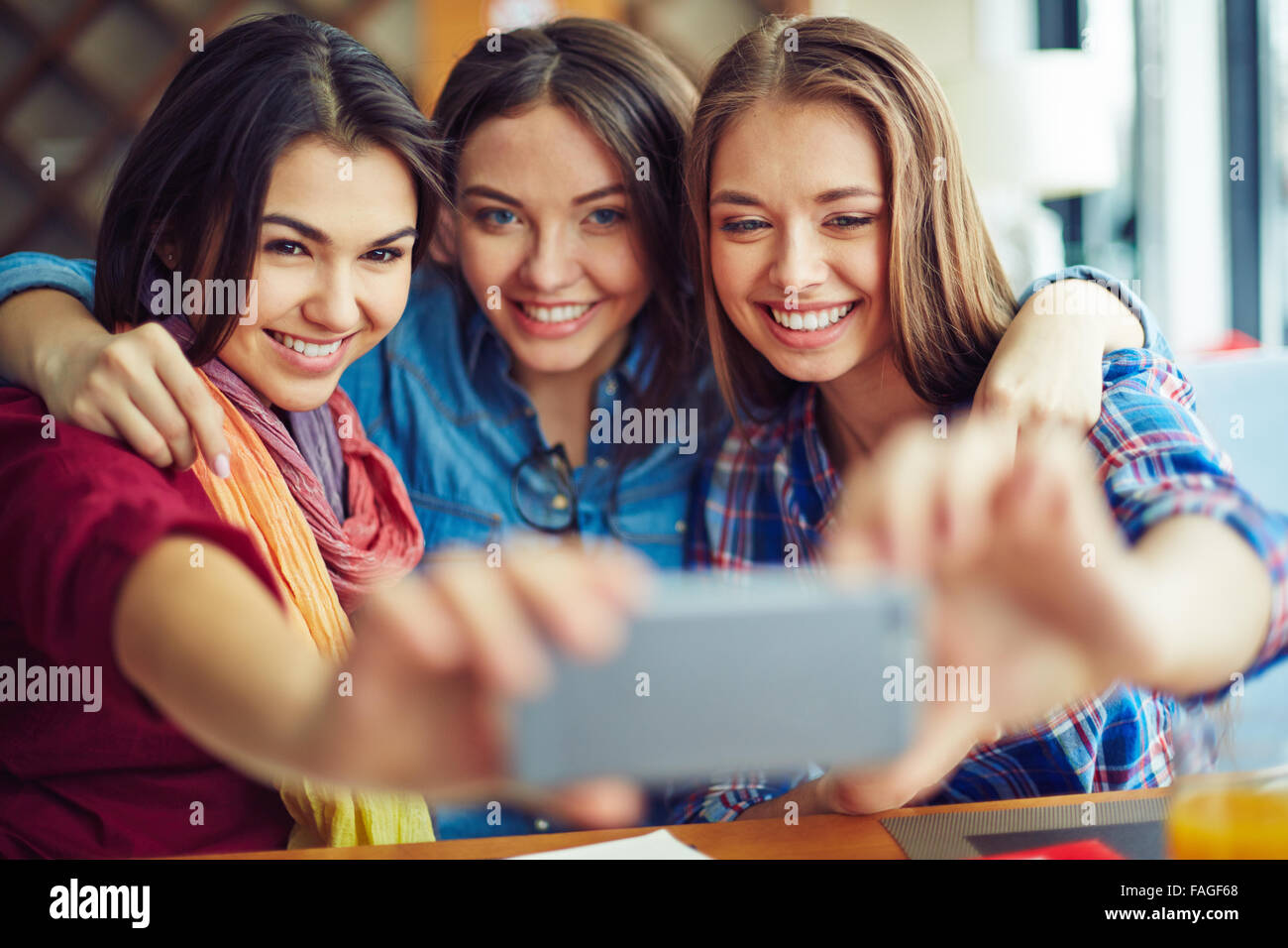 Friendly girls making selfie Stock Photo - Alamy